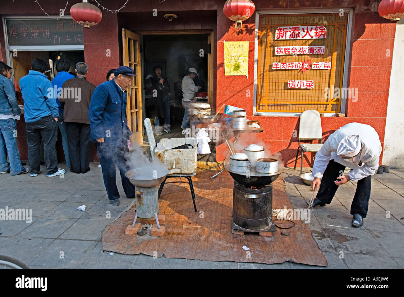CHINA BEIJING Tiny but busy neighborhood restaurant with chefs set up ...
