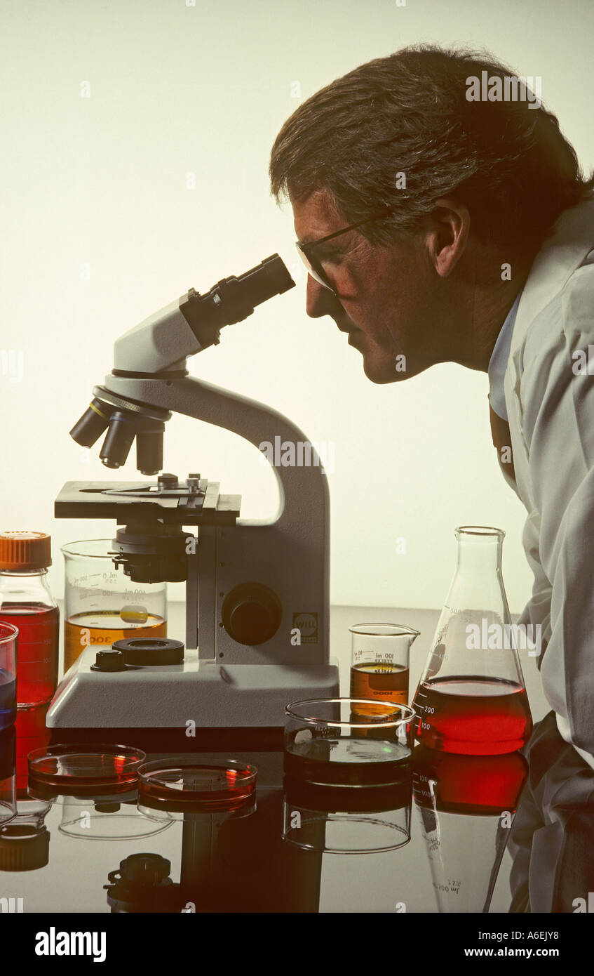 lab technician looking through microscope Stock Photo - Alamy