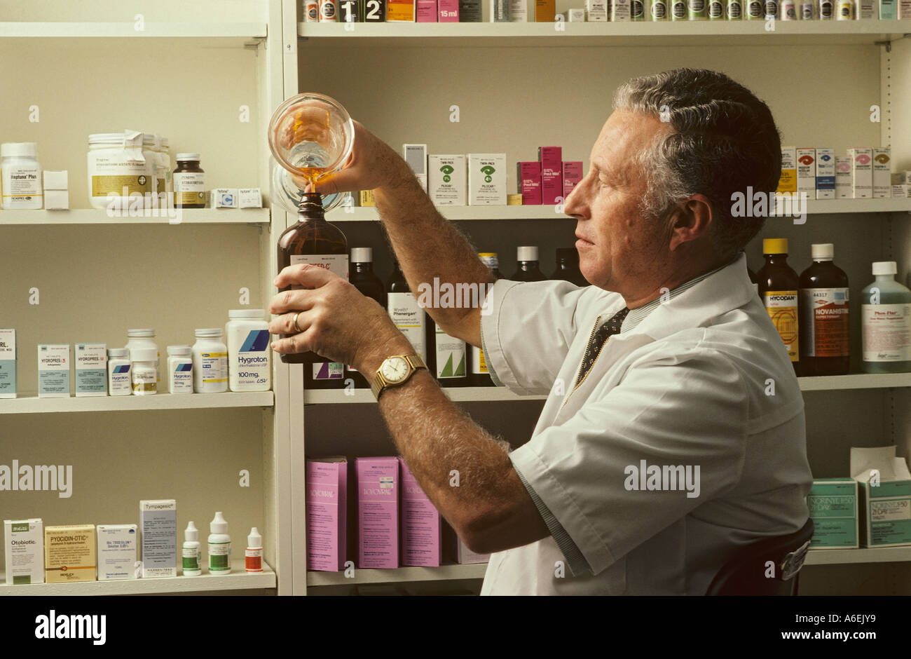 pharmacist mixing liquid drug in pharmacy Stock Photo - Alamy