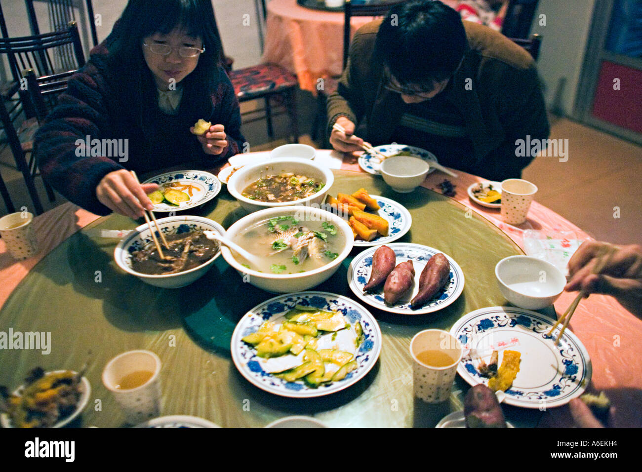 CHINA SIMATAI Chinese family eating shared dinner in rural village ...