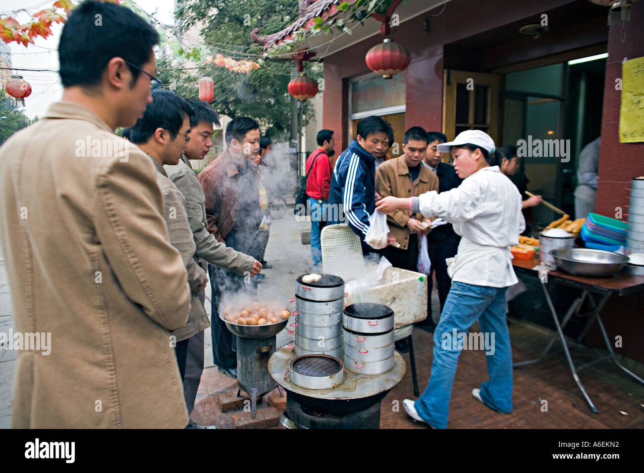 CHINA BEIJING Tiny but busy neighborhood restaurant with chefs set up ...