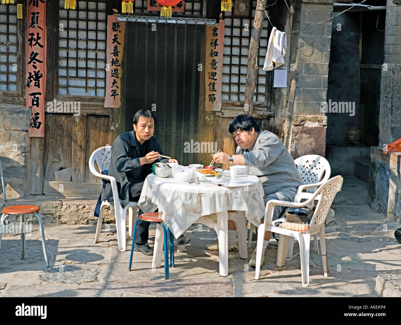 CHINA Chuandixia Chinese couple sharing family style lunch of many ...
