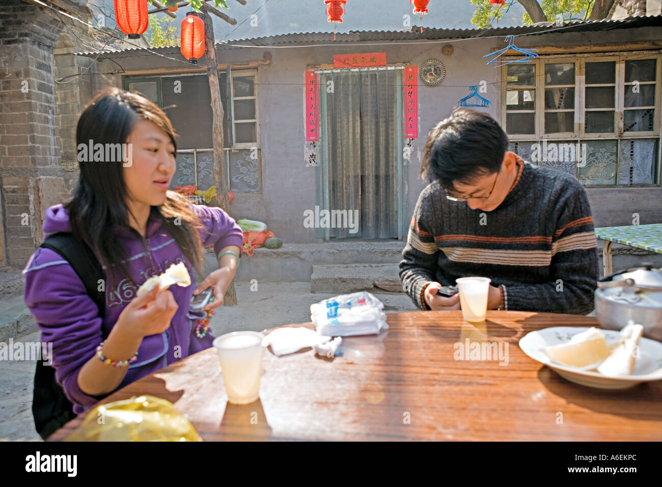 CHINA Chuandixia Chinese couple using cell phones as they share dessert ...