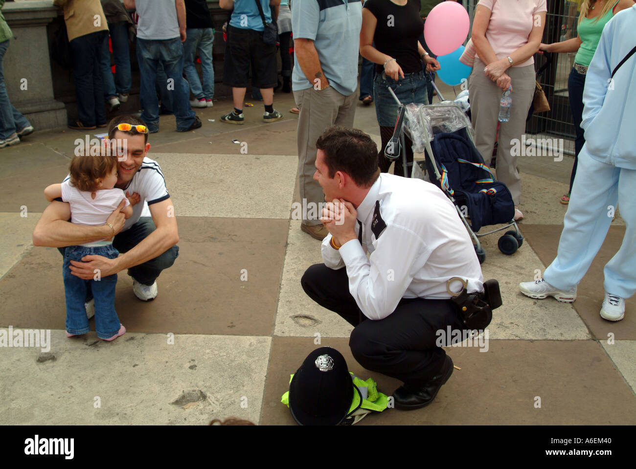 POLICE OFFICER HAVING A CONVERSATION WITH A FATHER AND CHILD LONDON ...