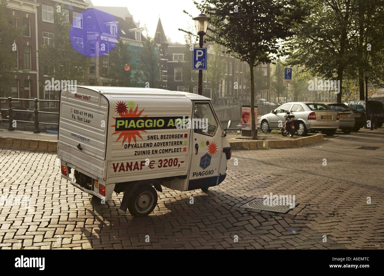 Tree wheeled van Ape of Piaggio in Amsterdamm in front of a Gracht ...
