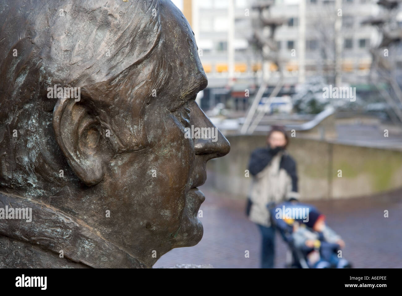 Woman pushing pram passing statue in Germany Stock Photo - Alamy
