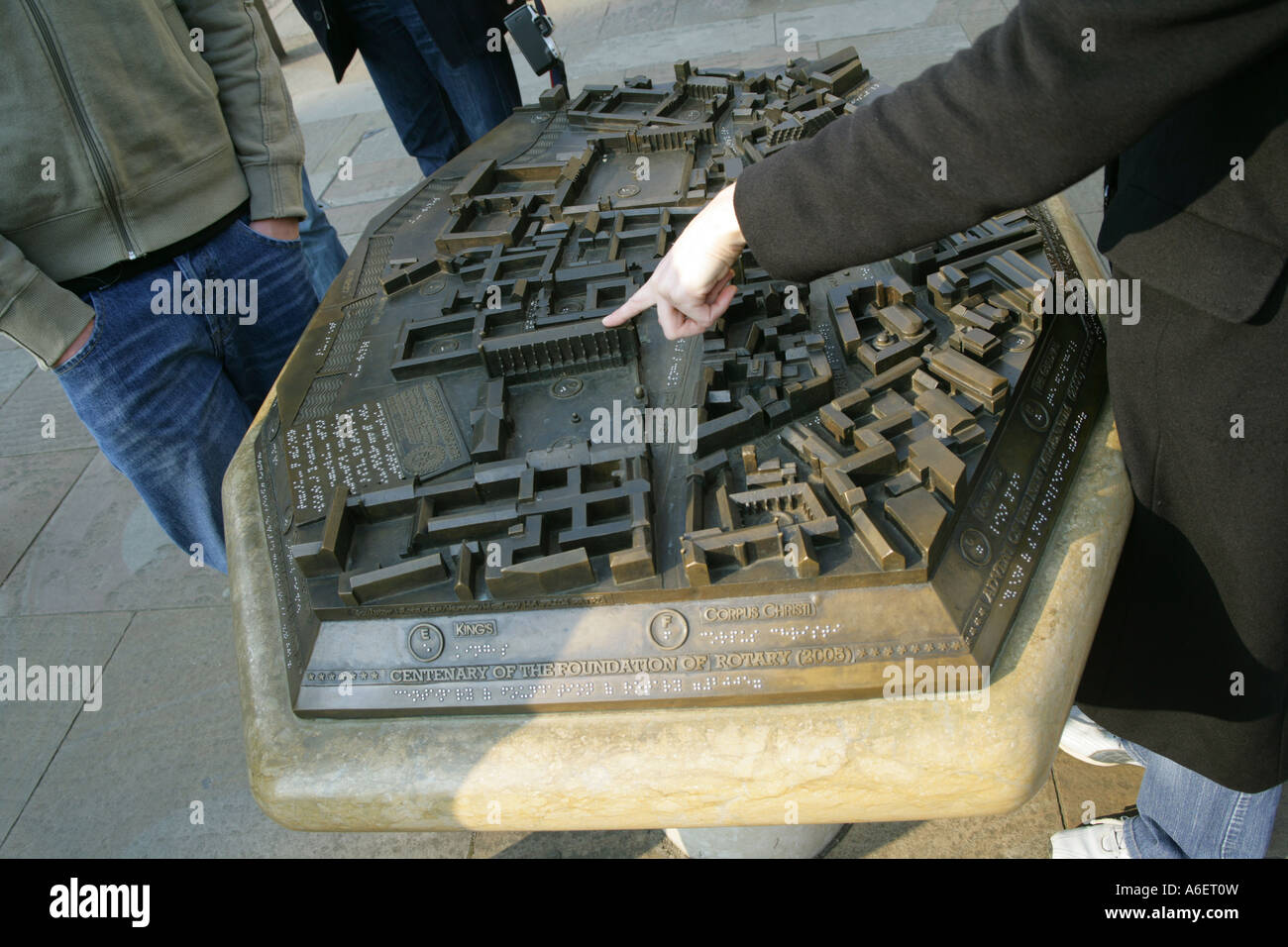 Three people gathered around an orientation table in the town centre ...