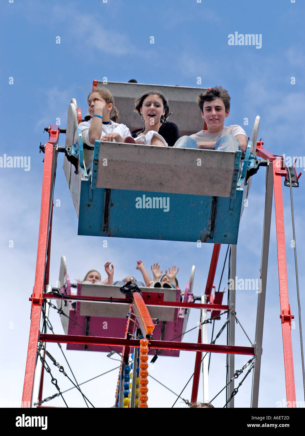 Teenage females enjoying an amusement park ride Stock Photo - Alamy