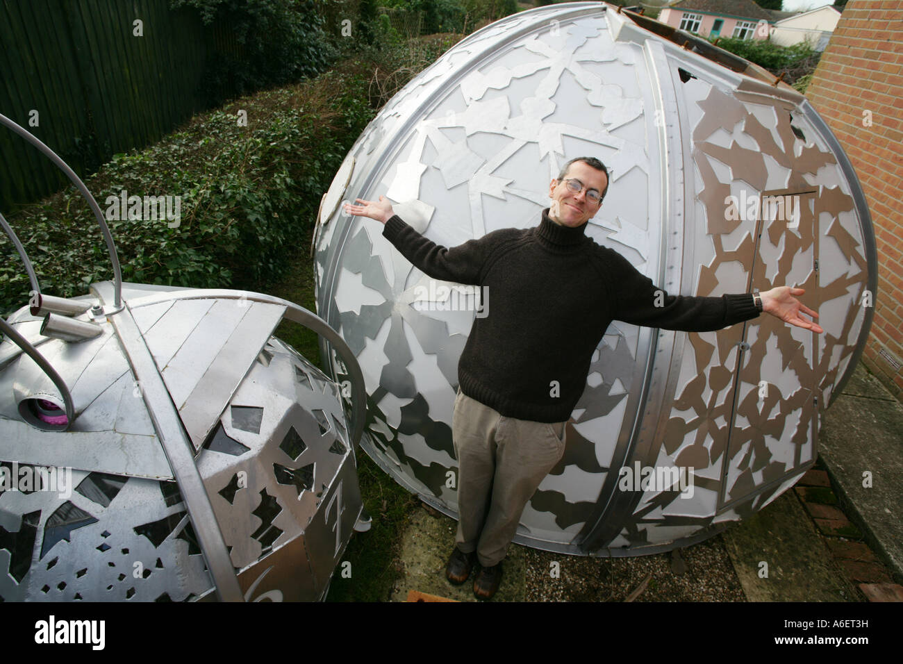 Sculptor MICHAEL CONDRON standing near his giant Christmassy work of ...