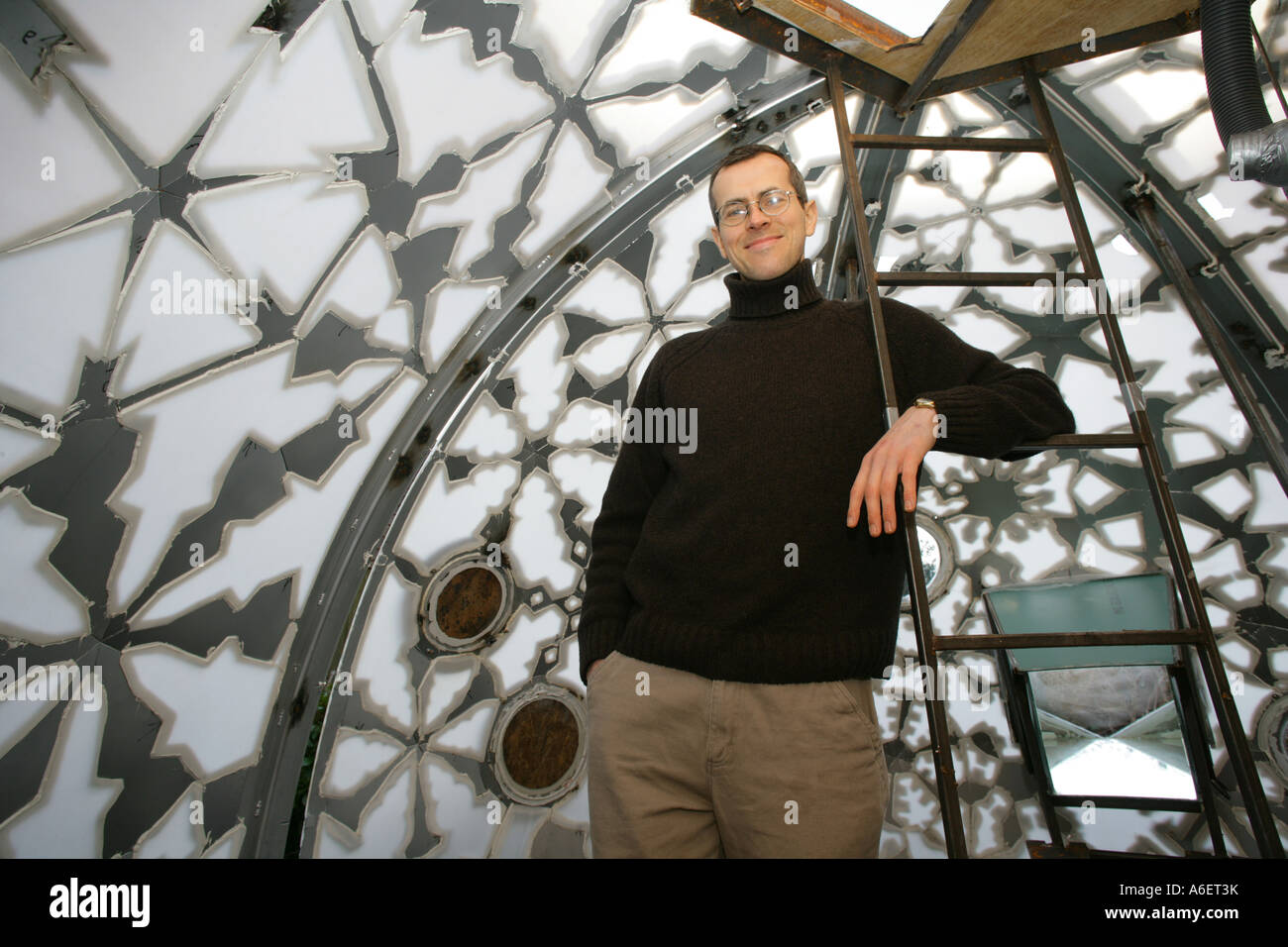 Sculptor MICHAEL CONDRON standing inside his giant Christmassy work of ...