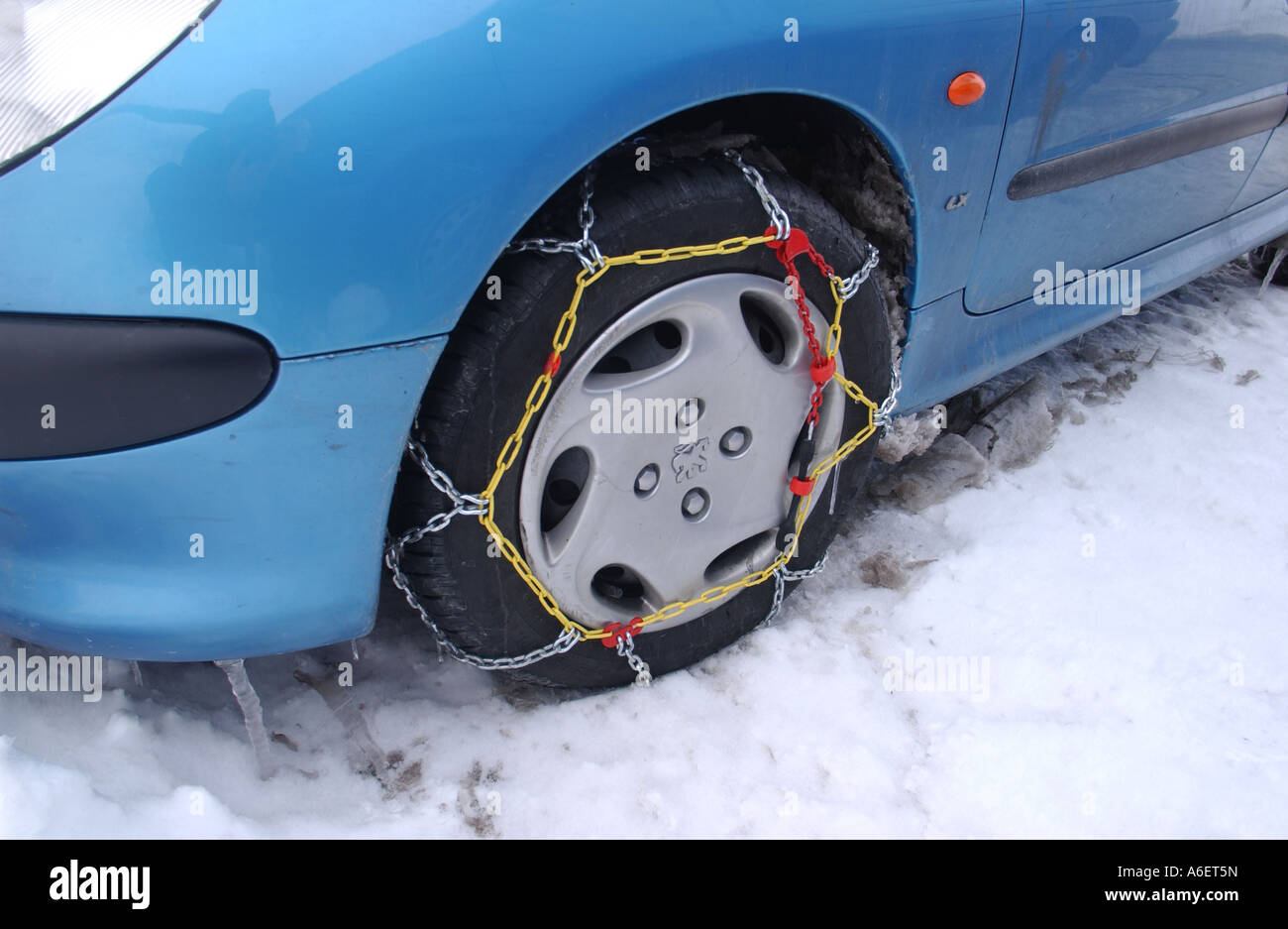Close up of car in snow with a snow chain fitted Stock Photo - Alamy