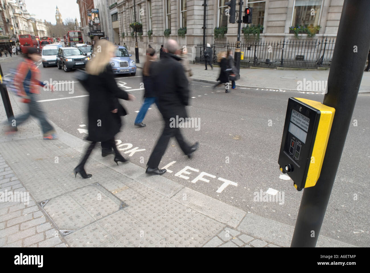 pedestrians crossing a busy London road (Whitehall) by a pedestrian ...