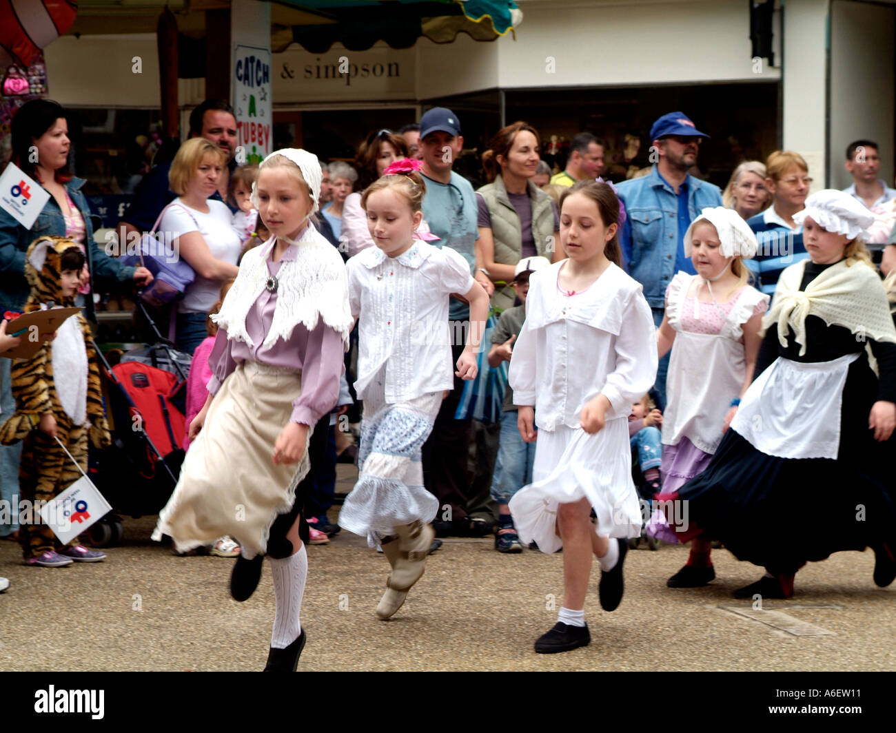 School children perform a May day dance routine dressed in traditional ...