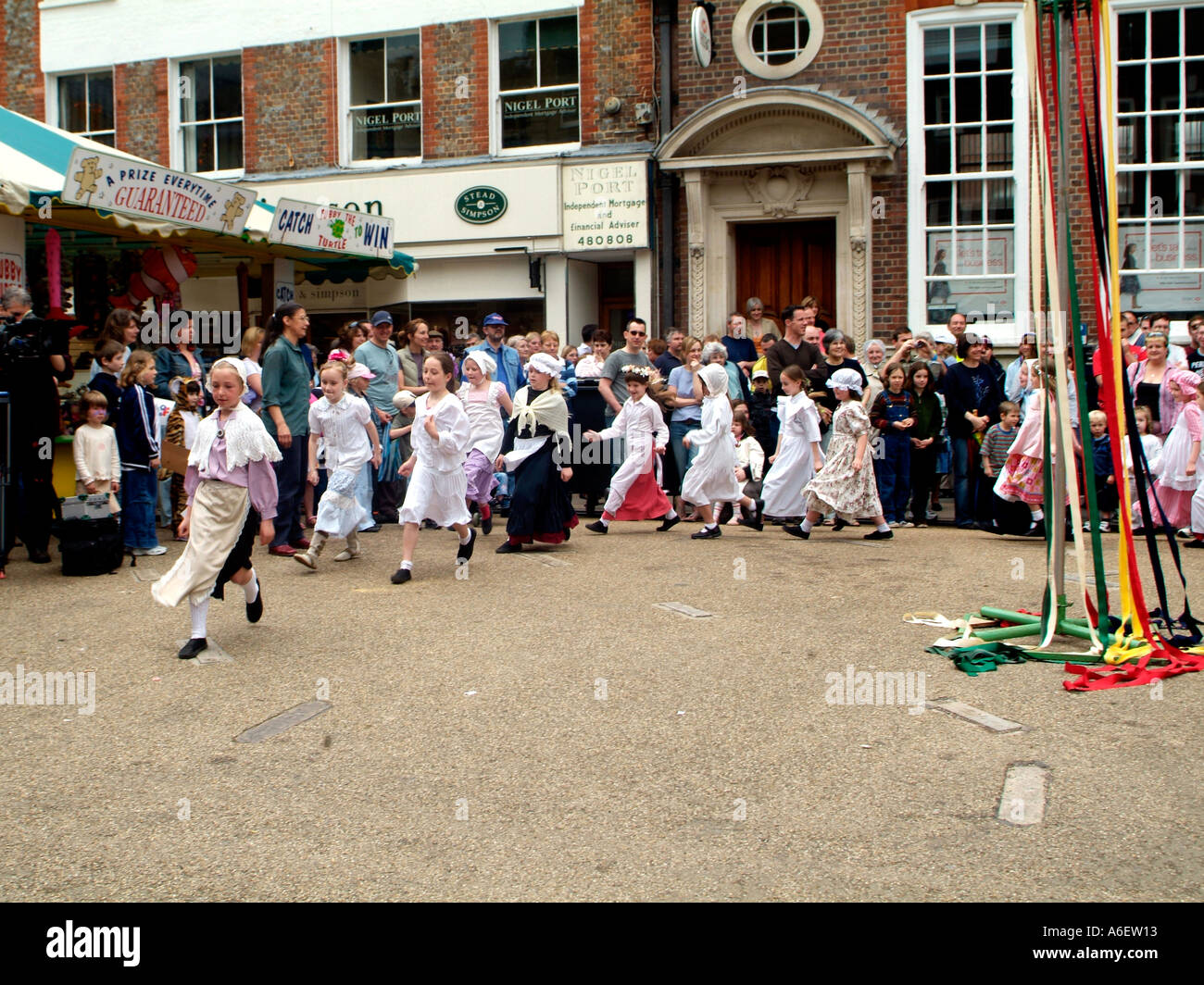 School children perform a May day dance routine dressed in traditional ...