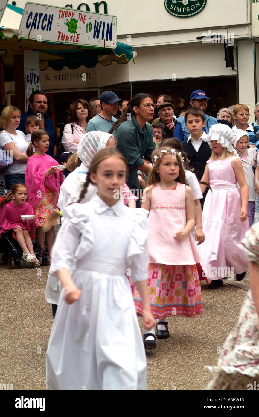 School children perform a May day dance routine dressed in traditional ...