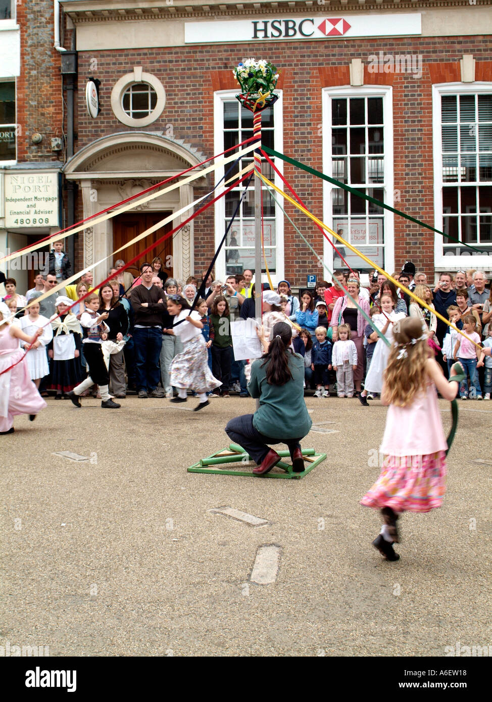 School children perform a Maypole dance routine dressed in traditional ...