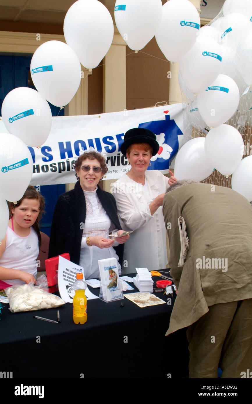 People working to collect money for charity by asking people to buy ...