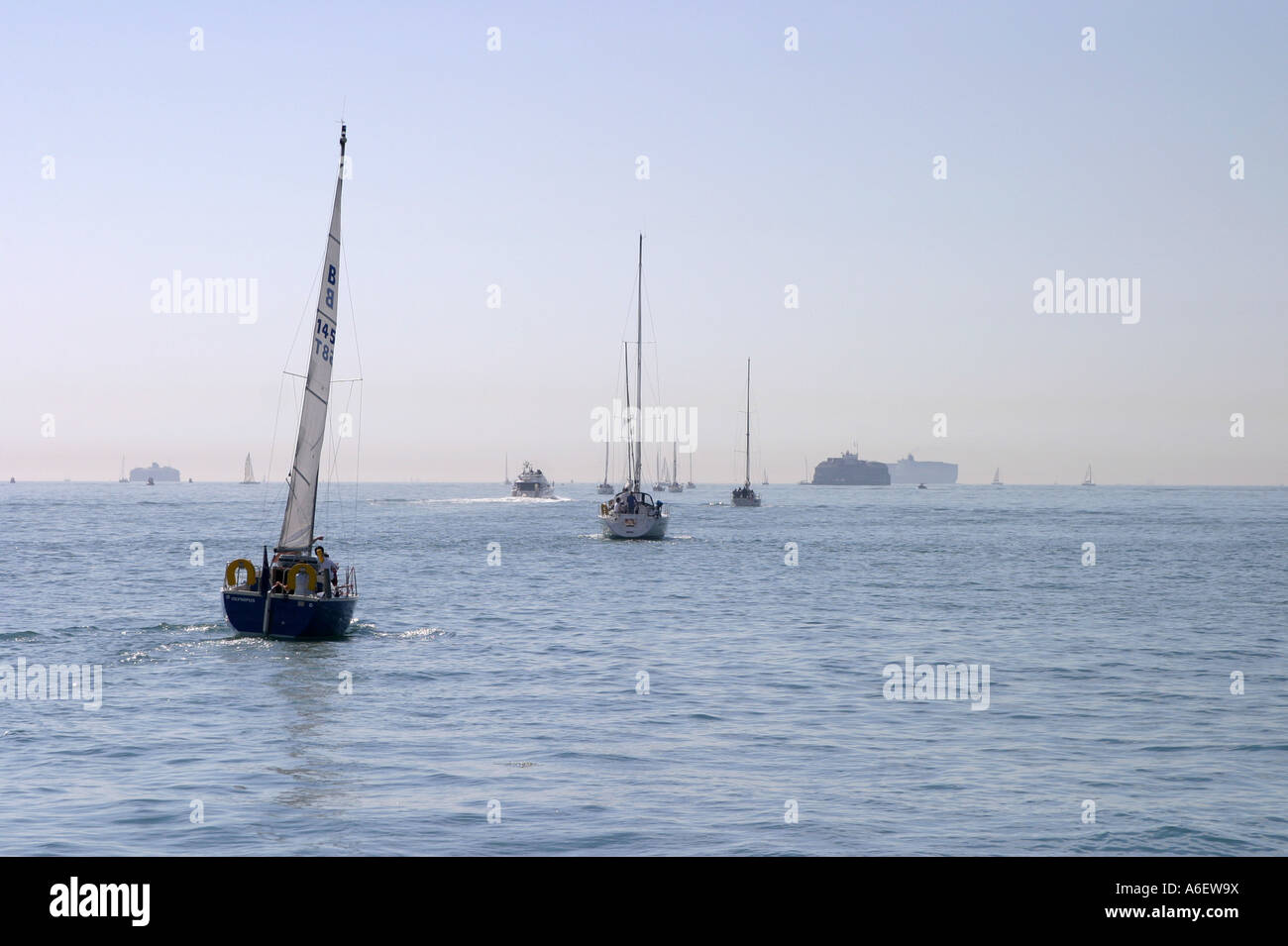 Yachts head out in line into the Solent, Portsmouth, Hampshire, England ...