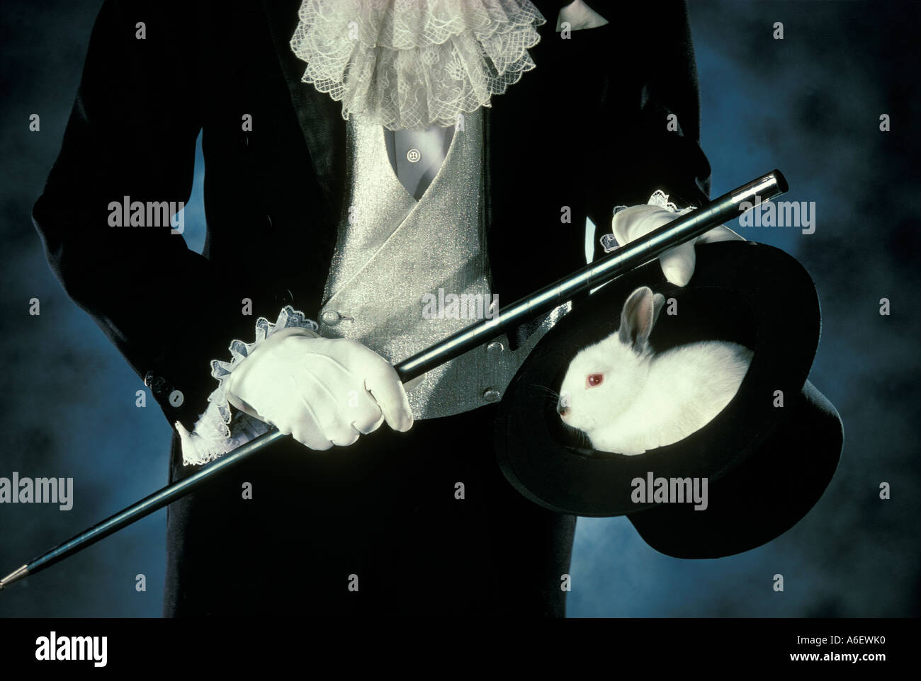 Magician pulls rabbit from top hat Stock Photo - Alamy