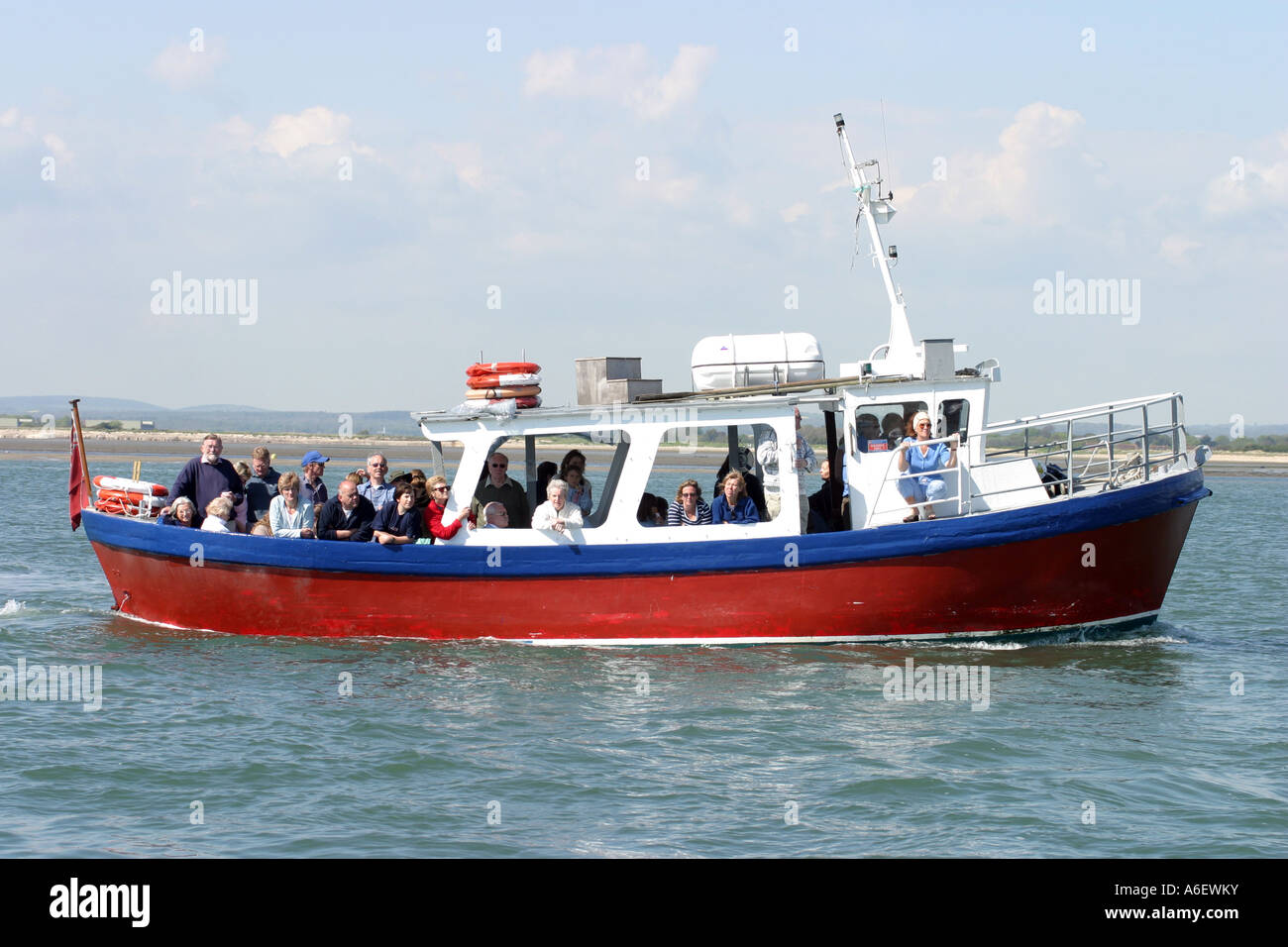 Holidaymakers look out from a small ferry, Sussex, England Stock Photo ...