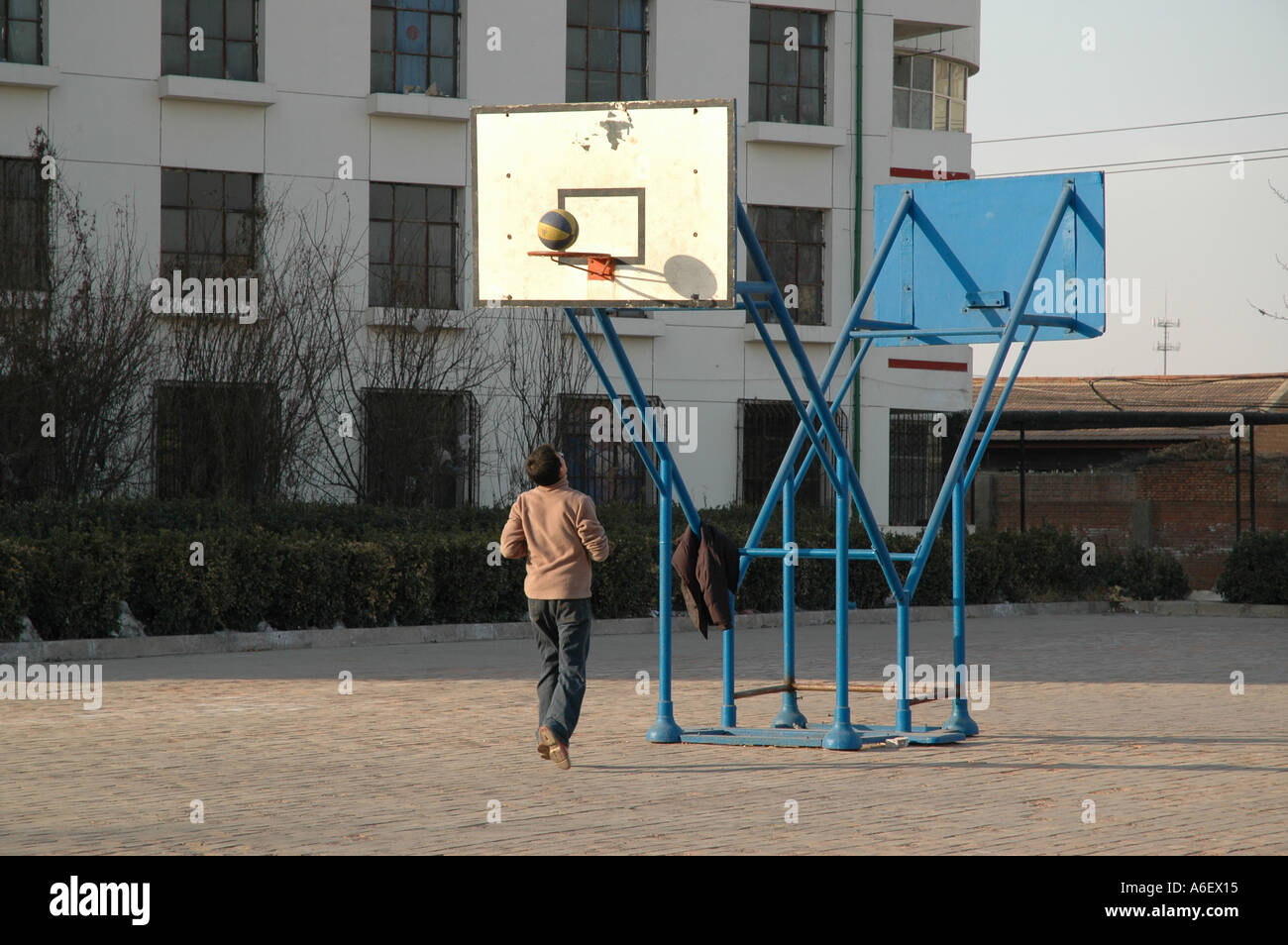 Student playing with a ball in the baseball field in the campus of the ...