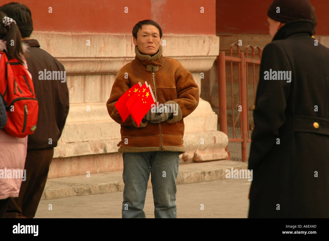 Tourist guide holding chinese flags in the interior of the Forbiden ...