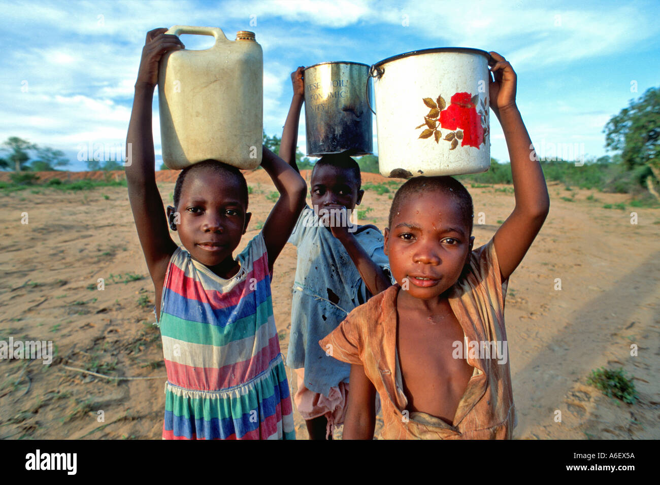 Girls from the Tonga tribe carrying water from a well. Zimbabwe Stock ...