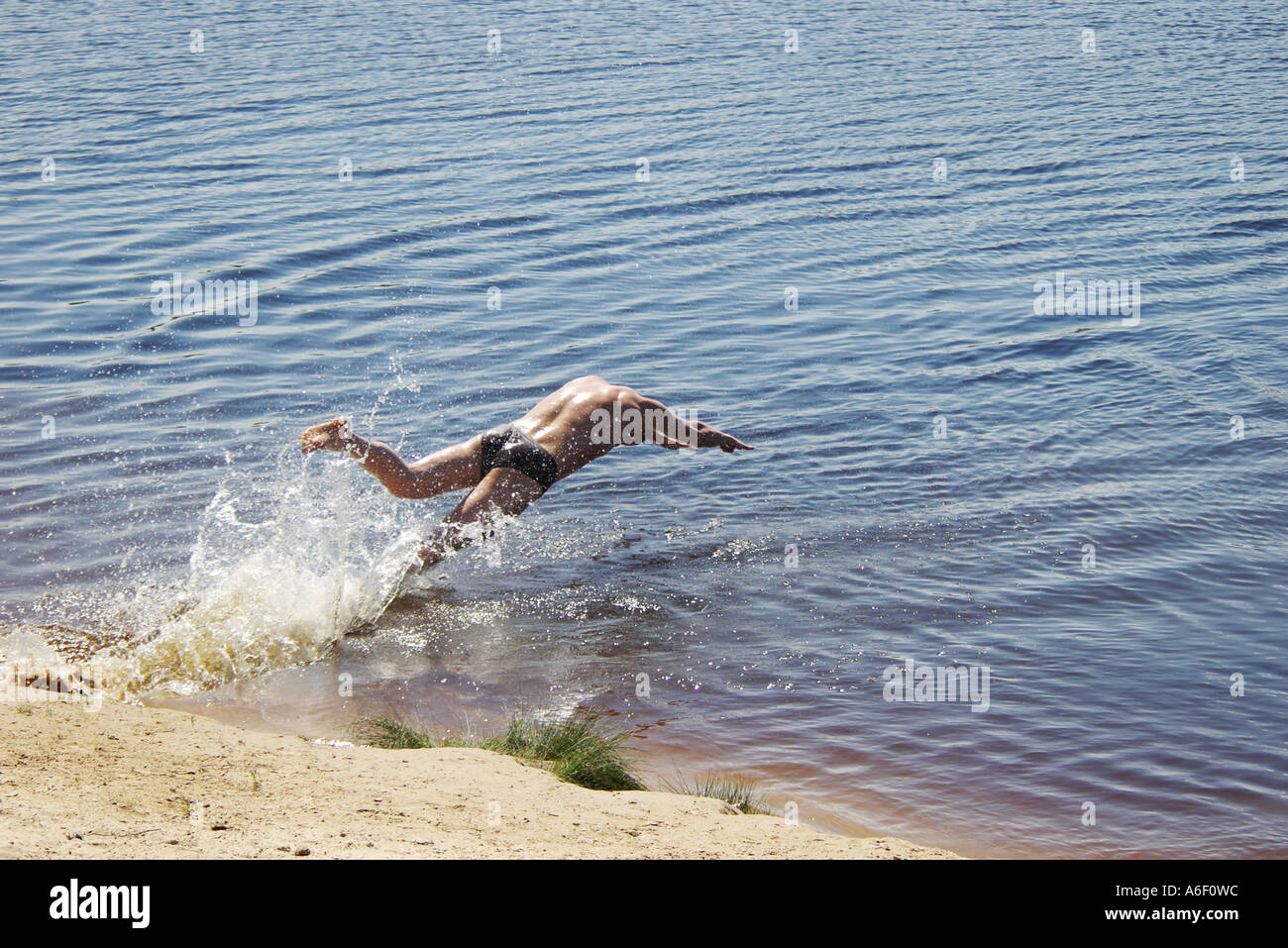 Man diving into water at the beach Stock Photo - Alamy