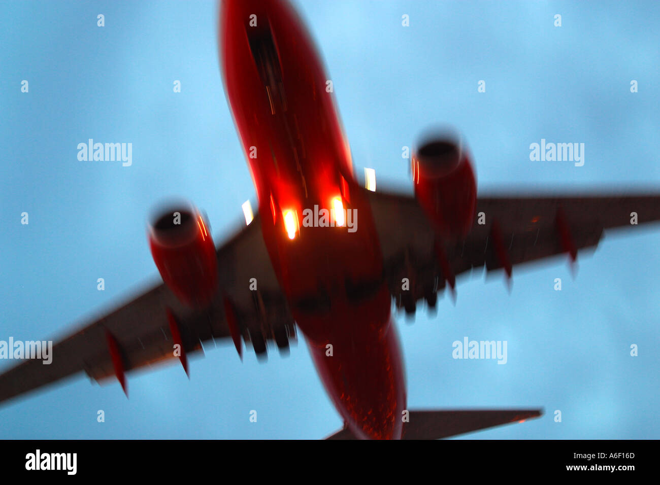 Underneath close up view of passenger jet flying overhead Stock Photo ...