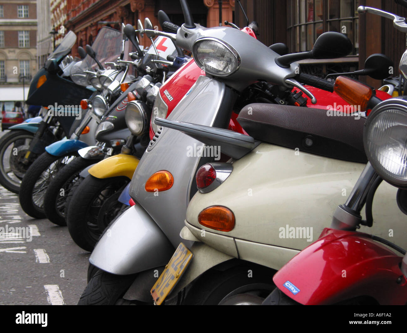 Line of Motor Scooters Motorcycles Parked in London Street Scene ...