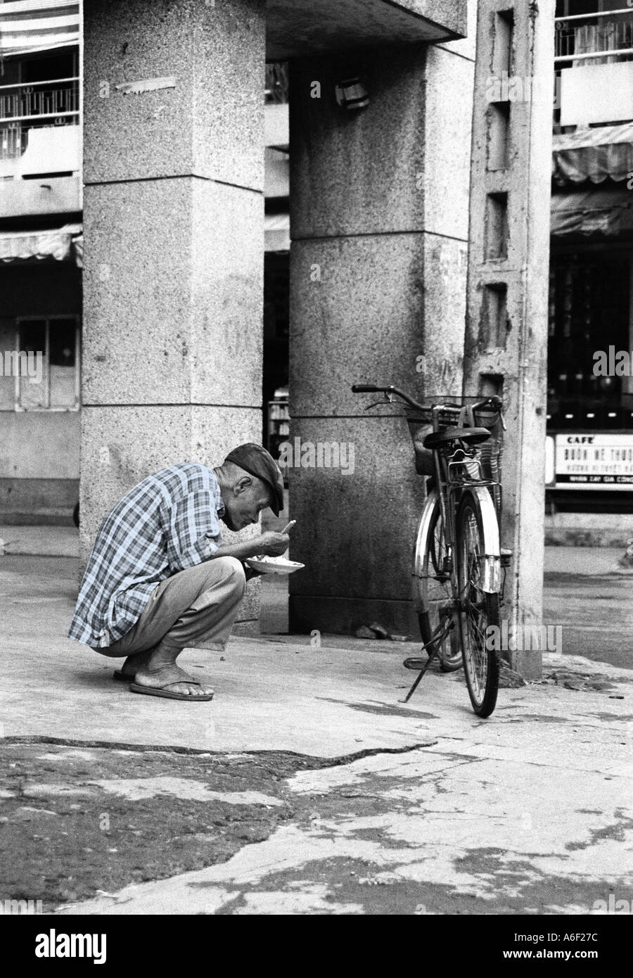 Man eating rice in downtown Saigon Stock Photo - Alamy
