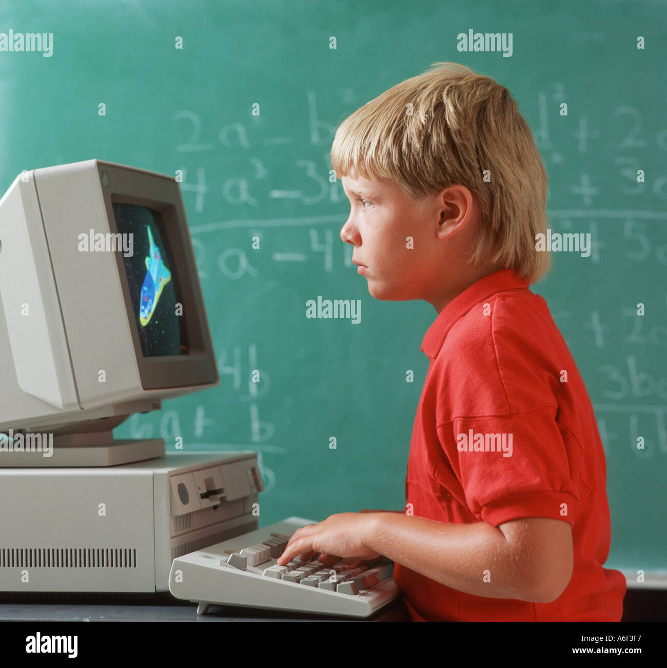 young boy working on computer in school classroom Stock Photo - Alamy