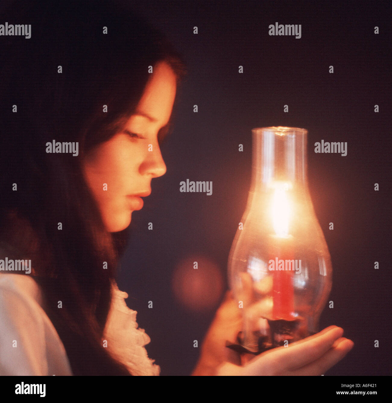young woman carrying lamp with candle Stock Photo - Alamy