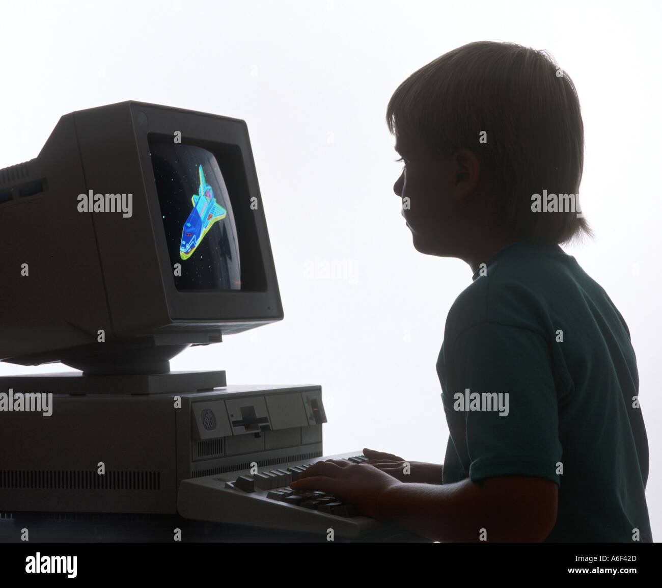 small boy on computer showing NASA shuttle on monitor Stock Photo - Alamy