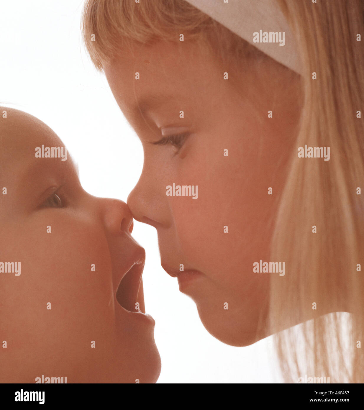 small girl touching noses with baby brother Stock Photo - Alamy