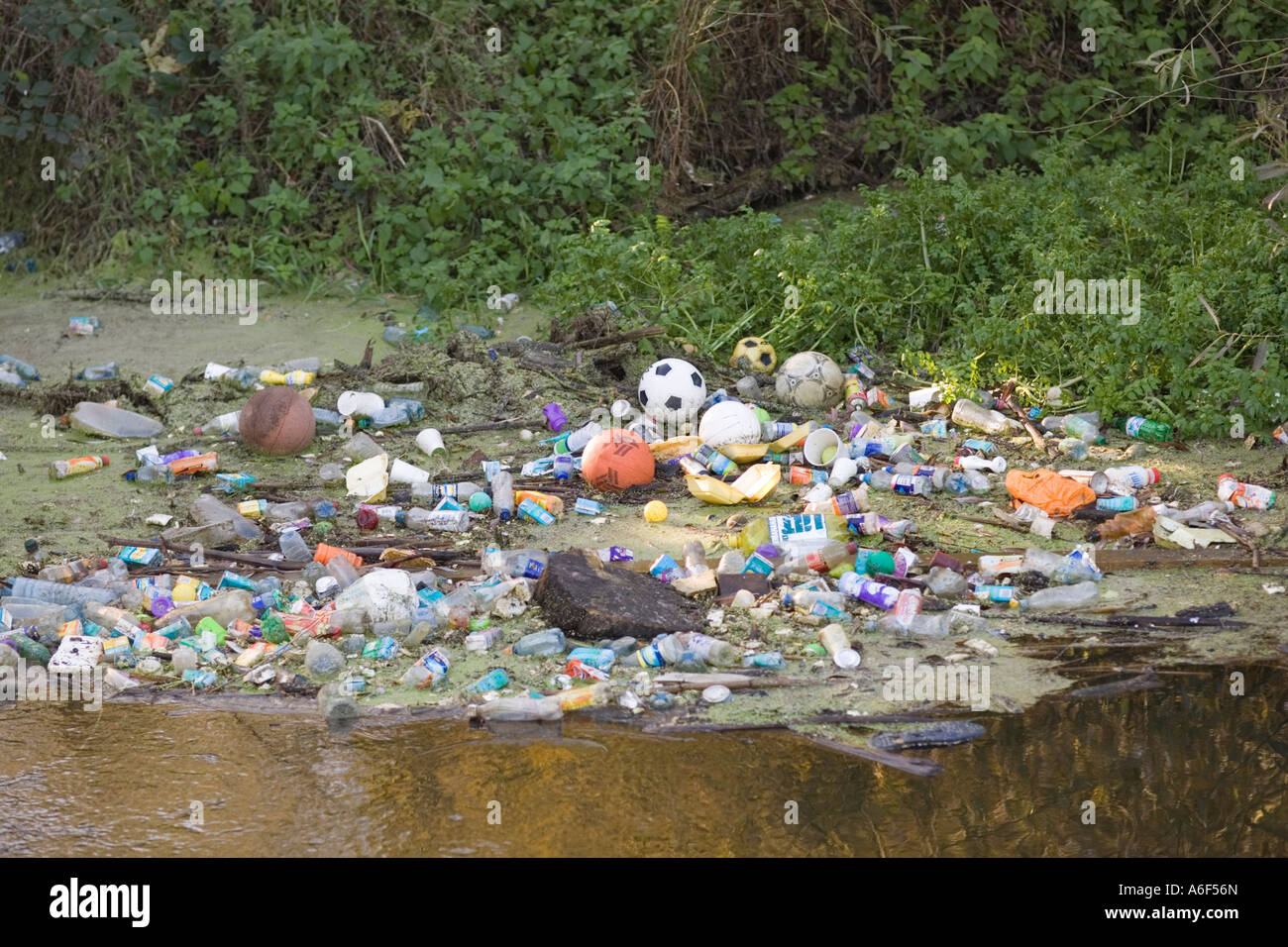 Rubbish build up on bend in river Stock Photo - Alamy