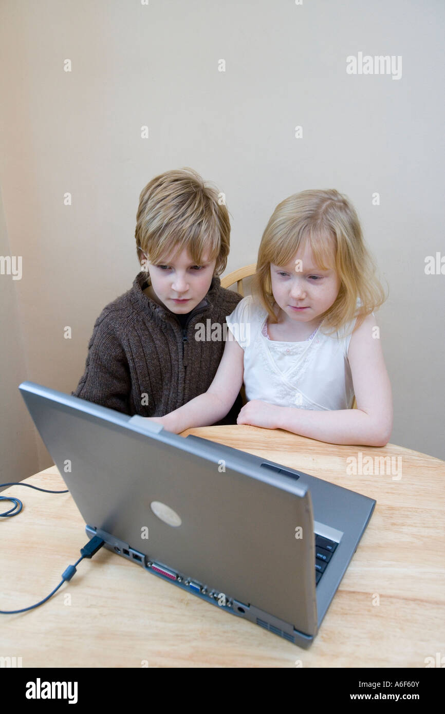 Young boy and girl using a laptop computer Stock Photo - Alamy