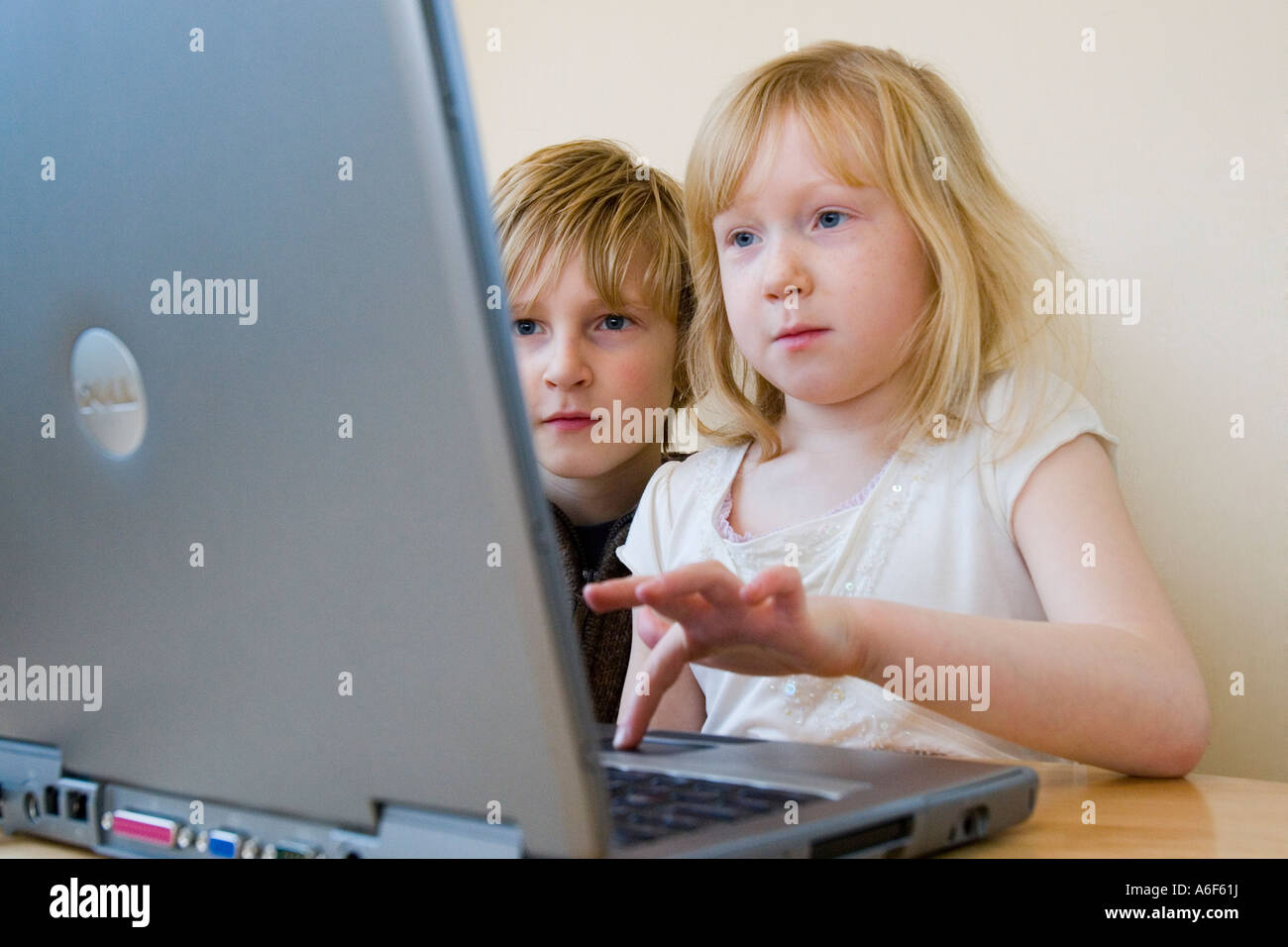Young boy and girl having fun using a laptop computer Stock Photo - Alamy