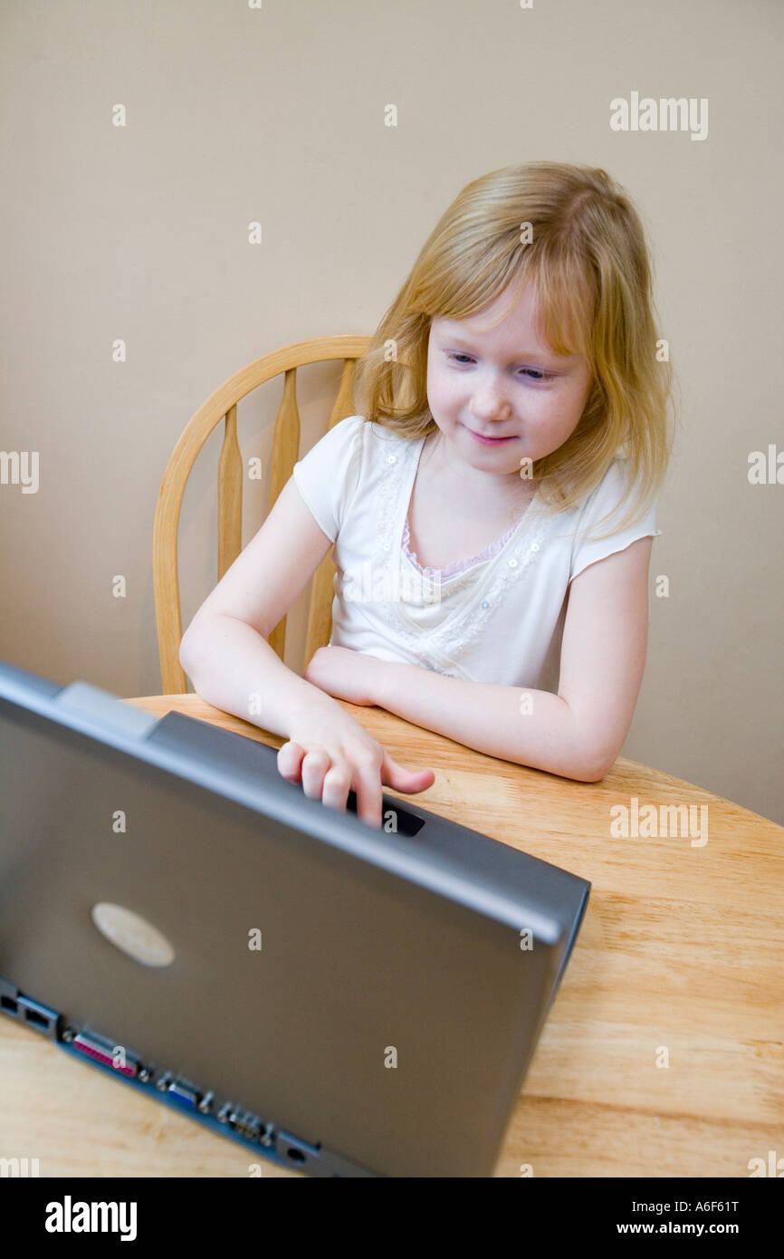 Young girl using a laptop computer Stock Photo - Alamy
