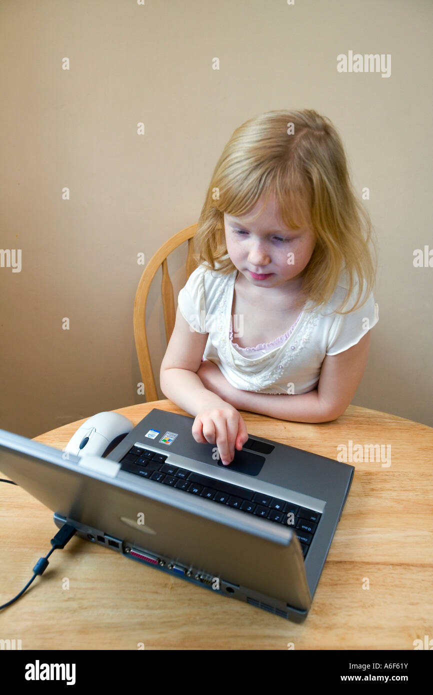 Young girl using a laptop computer Stock Photo - Alamy