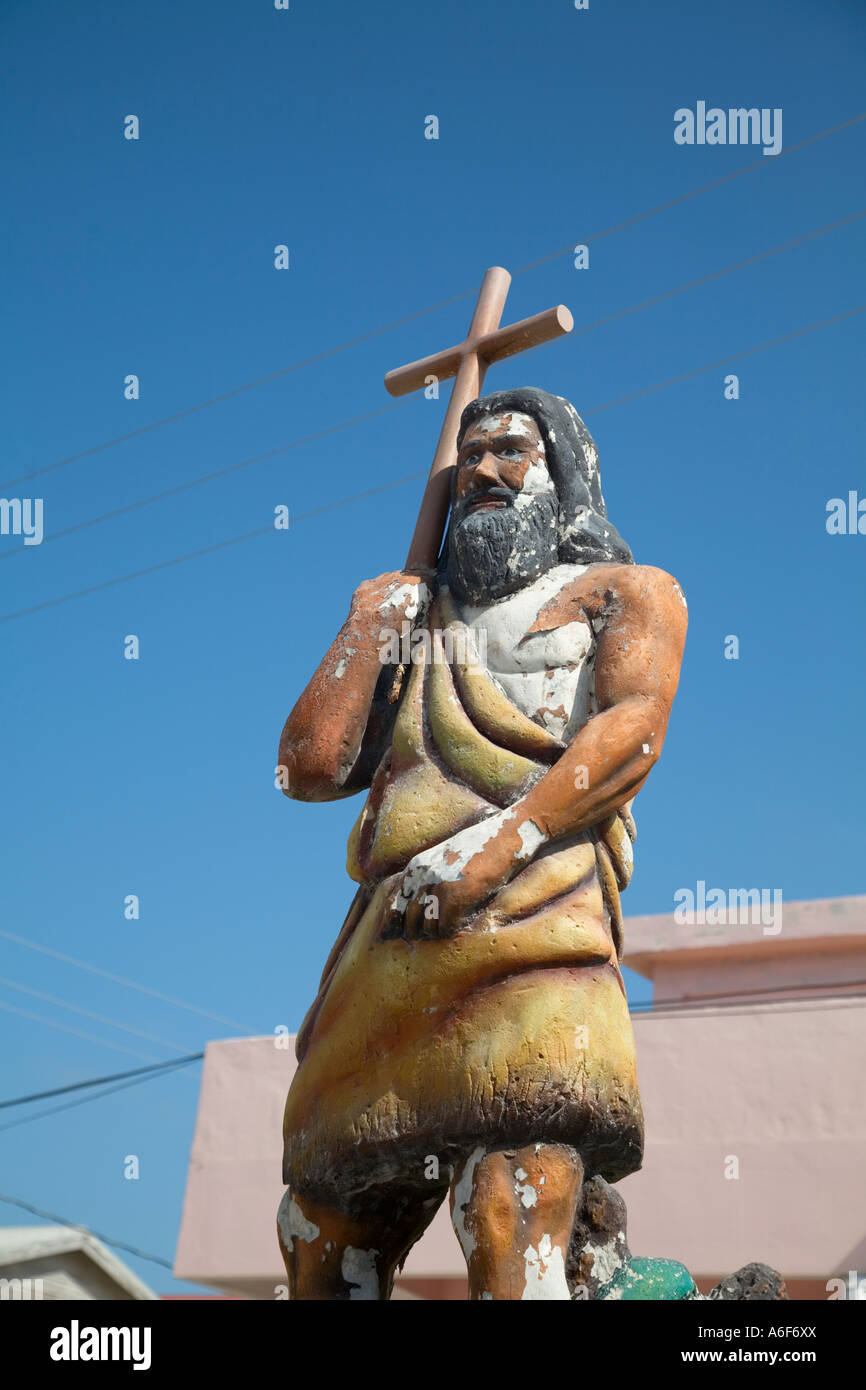 BELIZE San Pedro on Ambergris Caye Statue of bearded man holding cross ...
