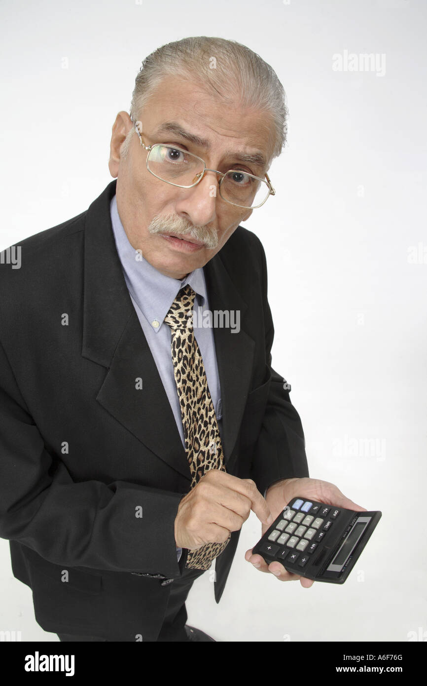 Old man holding calculator and looking into the lens wearing suit ...