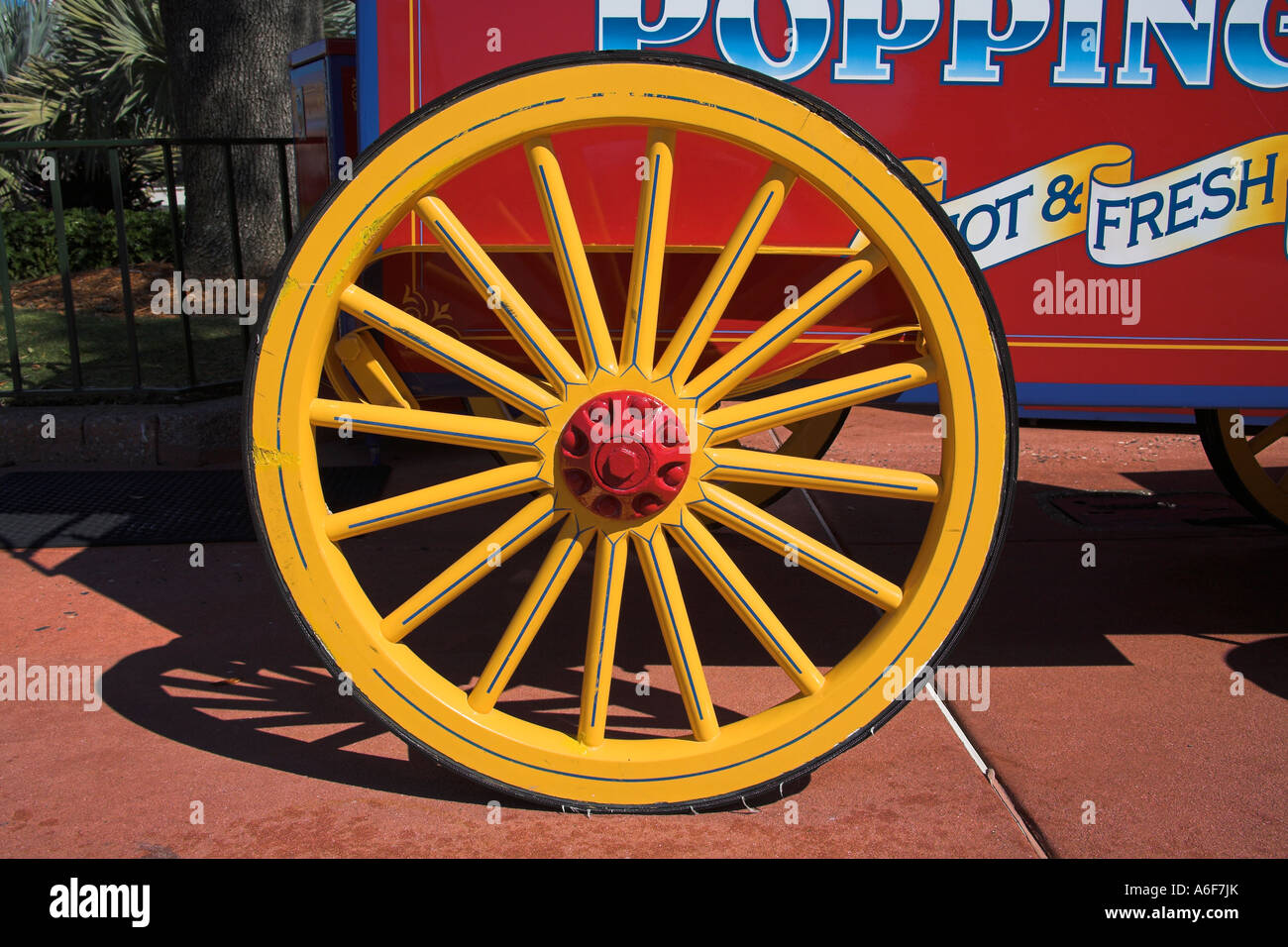 Yellow brightly painted wheel of popcorn stall, EPCOT Center, Disney ...