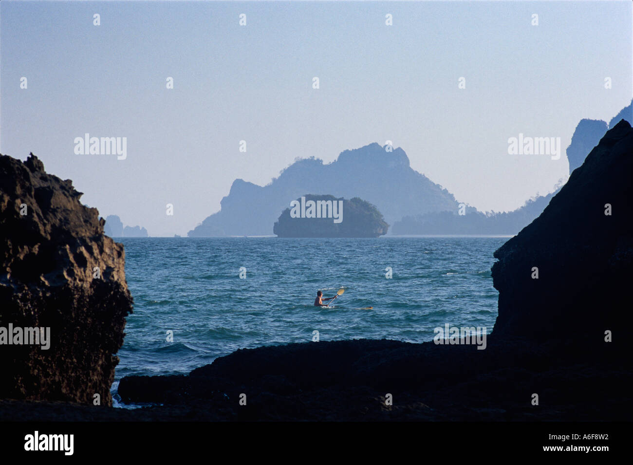 Kayaker in the Andaman Sea amid karst towers off Tonsai Beach, Krabi ...