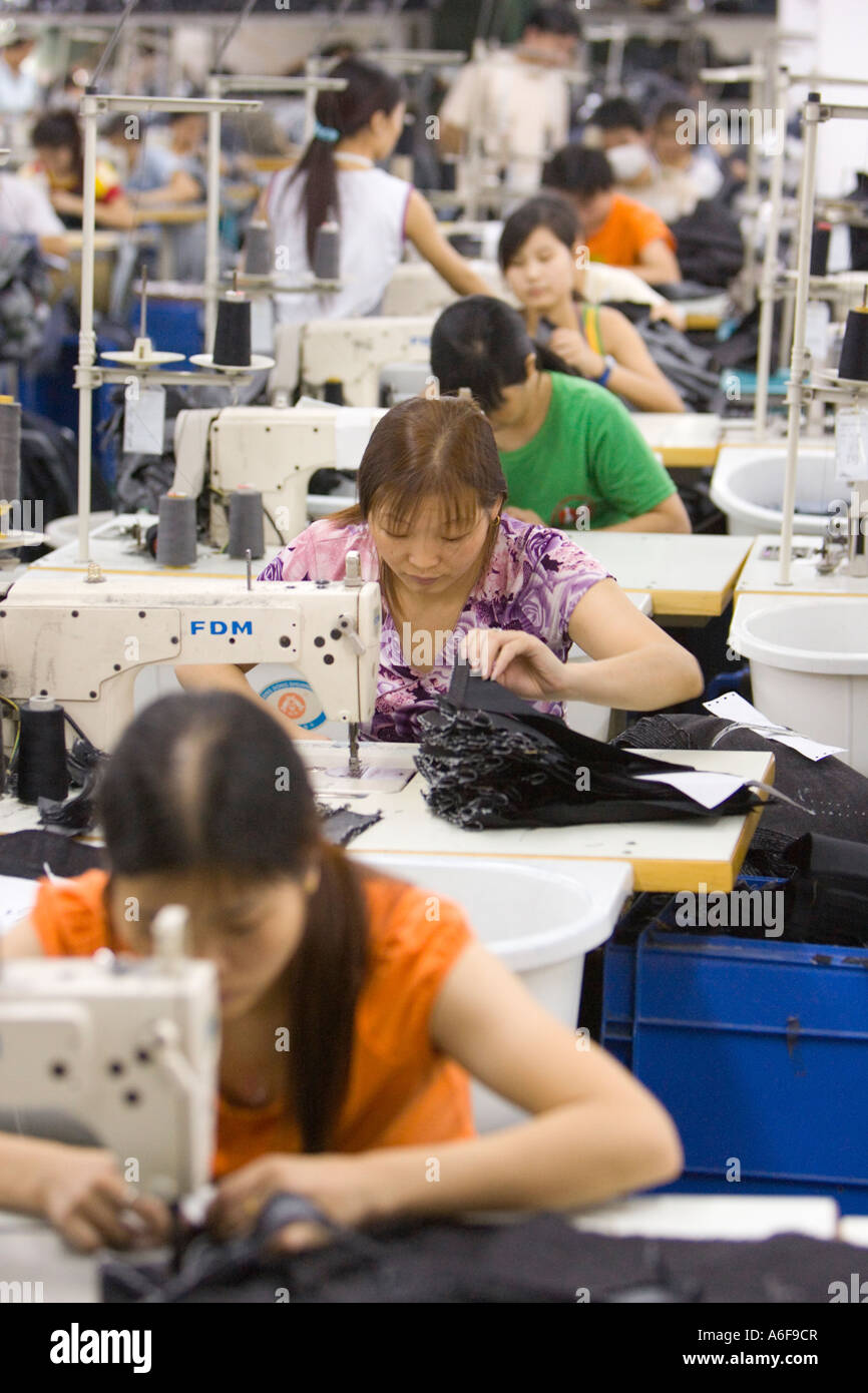 Female textile employees sewing garments hi-res stock photography and ...