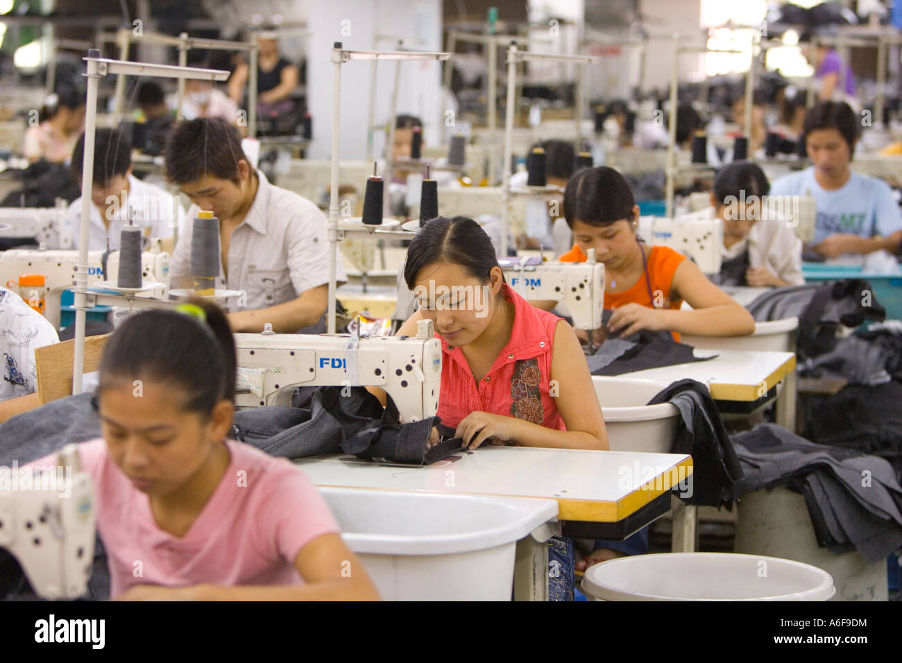 SHENZHEN GUANGDONG PROVINCE CHINA Workers sewing Mango jeans in garment ...