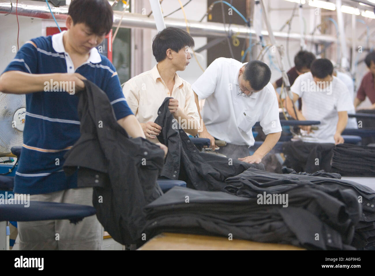 Ironing garment in clothing factory hi-res stock photography and images ...