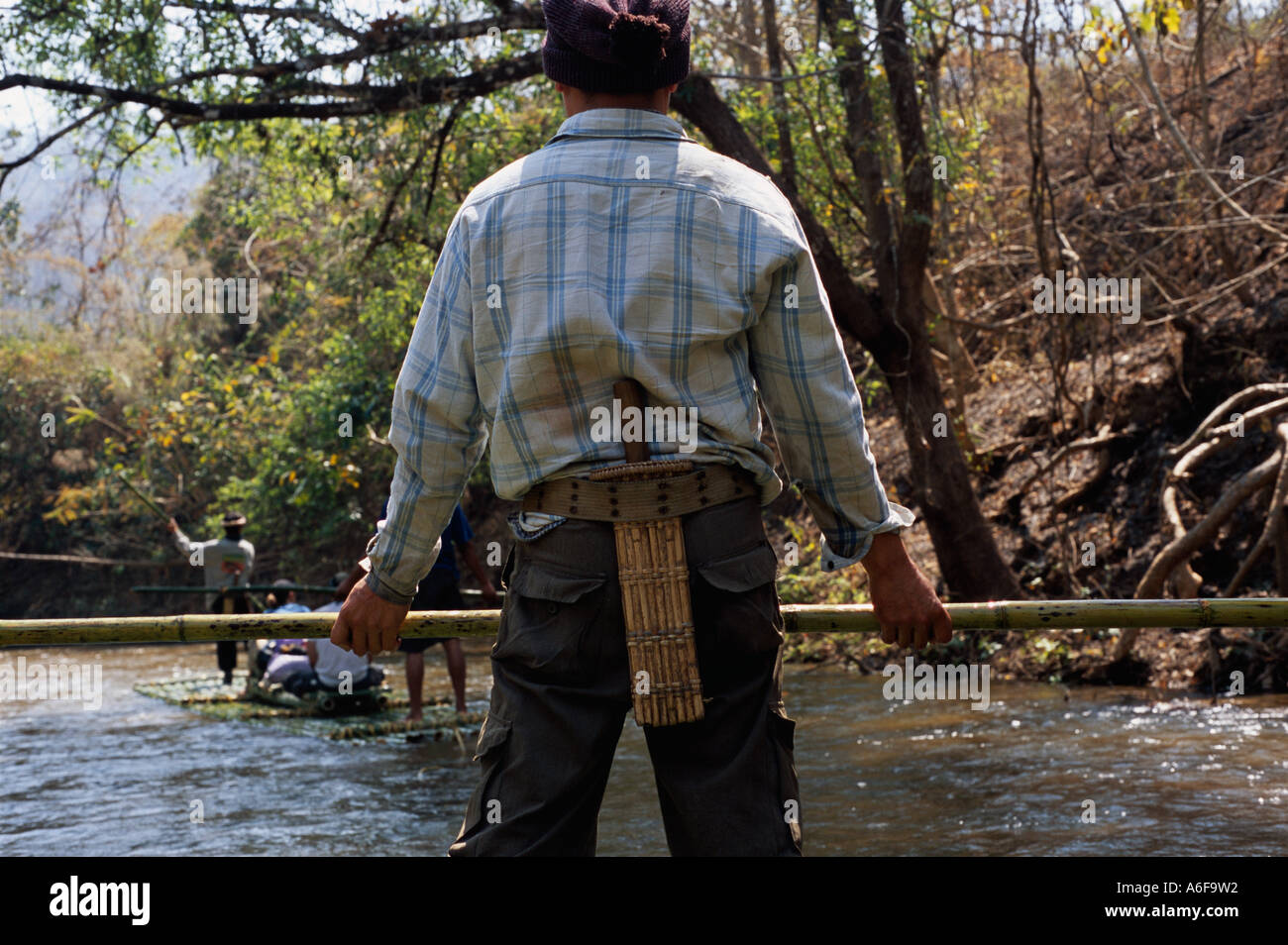 Raft guide with machete on Pai river, Thailand Stock Photo - Alamy