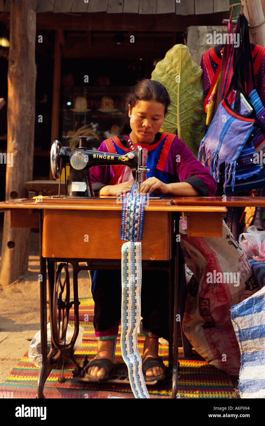 Hilltribe woman sews with treadle sewing machine on the street Pai ...