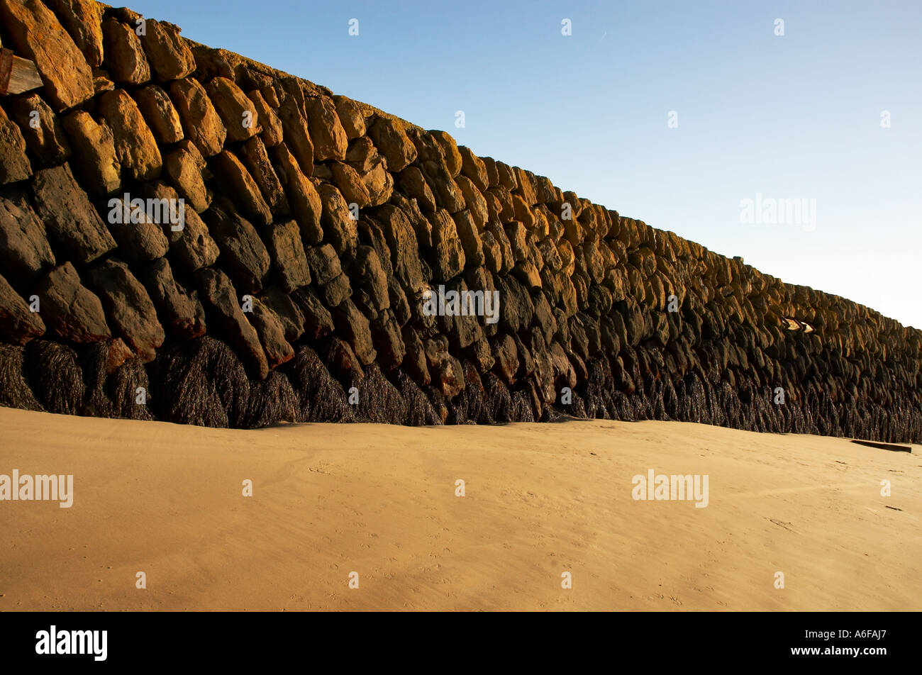 sand, wall, blue sky, defence, groin, harbour, sunshine, rocks Stock ...